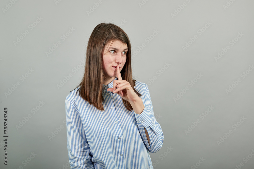 Index finger on lips, silence gesture, shhh quiet, asks for ...