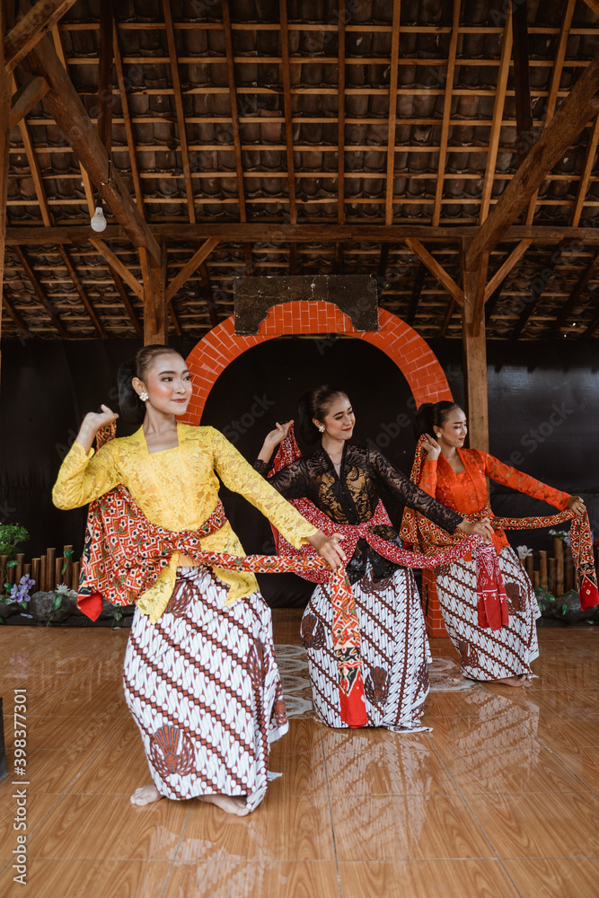 portrait of three young women presenting traditional Javanese dance ...