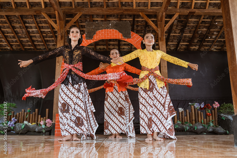 portrait of three young women presenting traditional Javanese dance ...