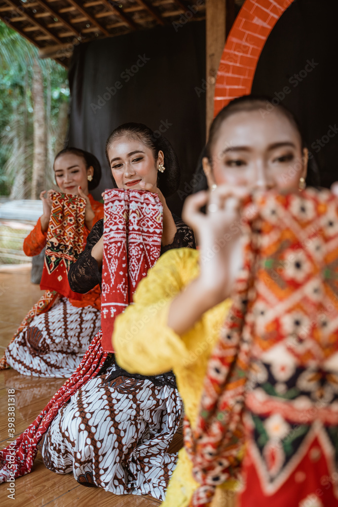 portrait of three young women presenting traditional Javanese dance ...