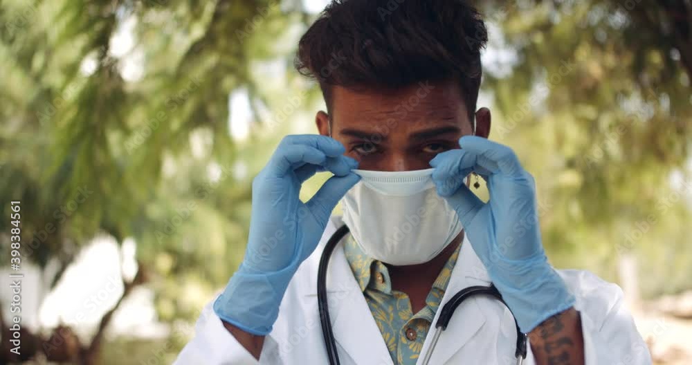 Slow-motion close-up CU shots of a doctor adjusting surgical gloves to ...
