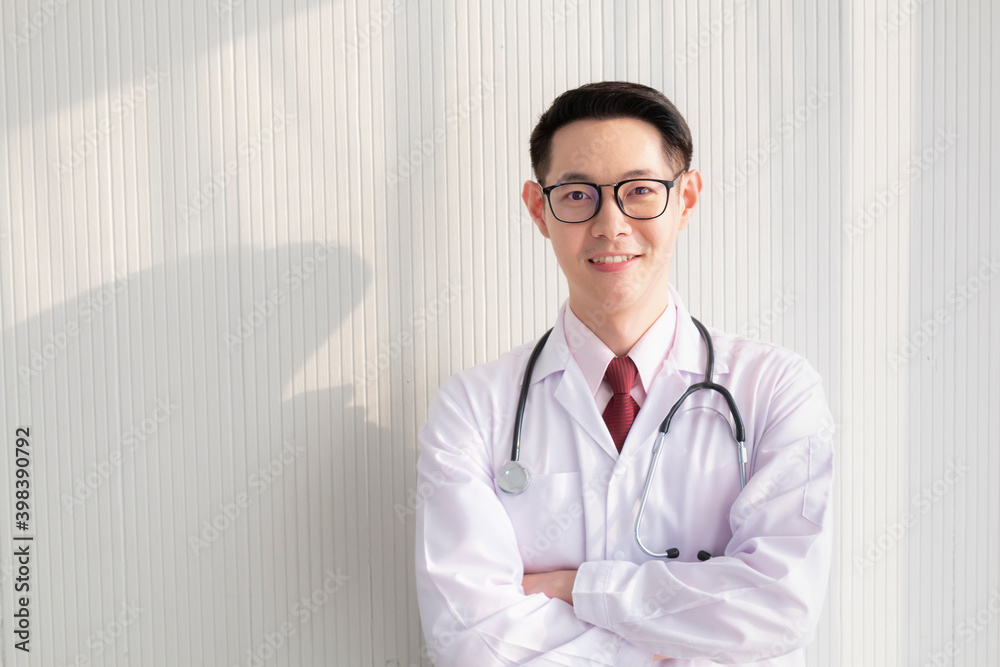 Portrait of young doctor with stethoscope office wall background ...