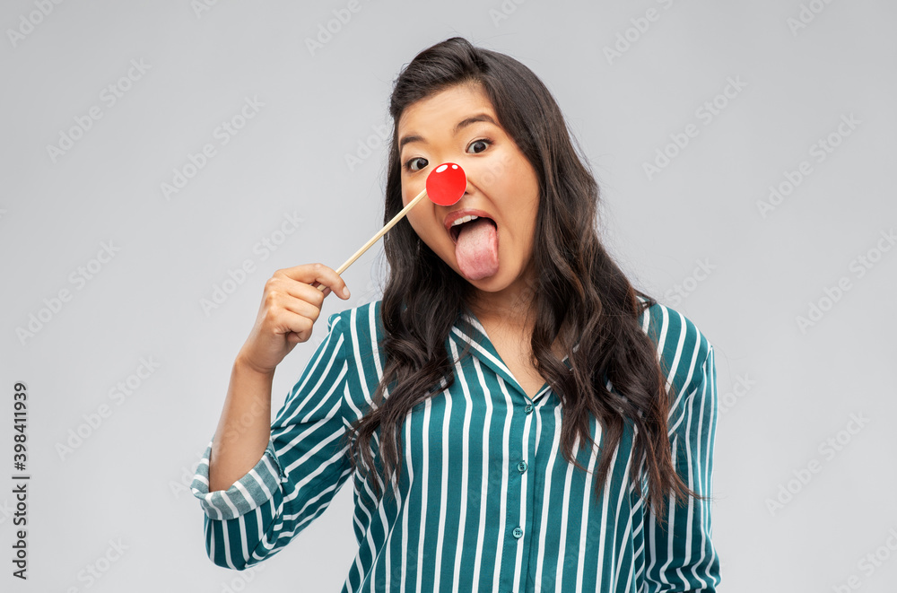 red nose day, party props and photo booth concept concept - happy asian ...
