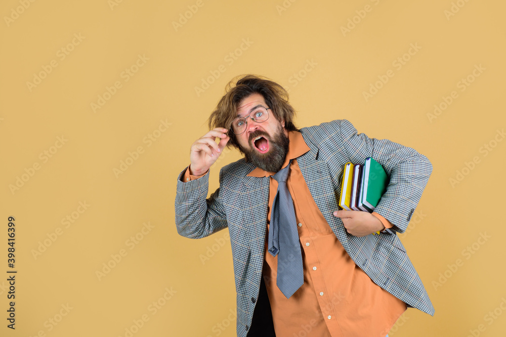 Confused teacher with books. Bad teacher. Bearded man in suit ...