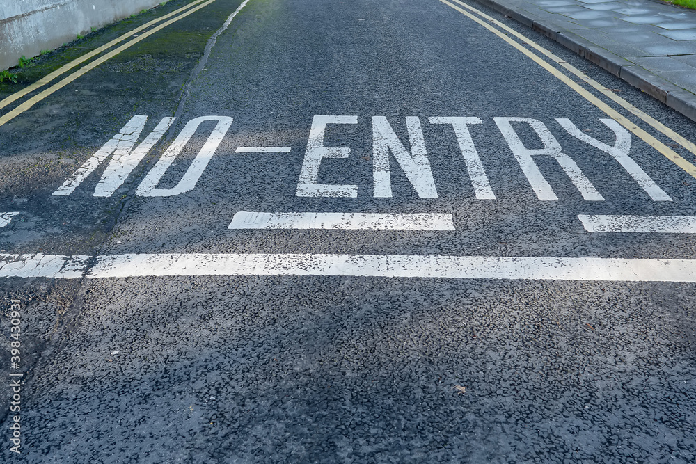 No entry sign on an asphalt road in town. Warning information for ...