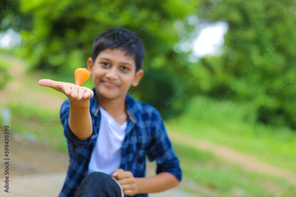 Foto de Cute indian little child playing Lattu, Bhovra or Bambaram is a ...