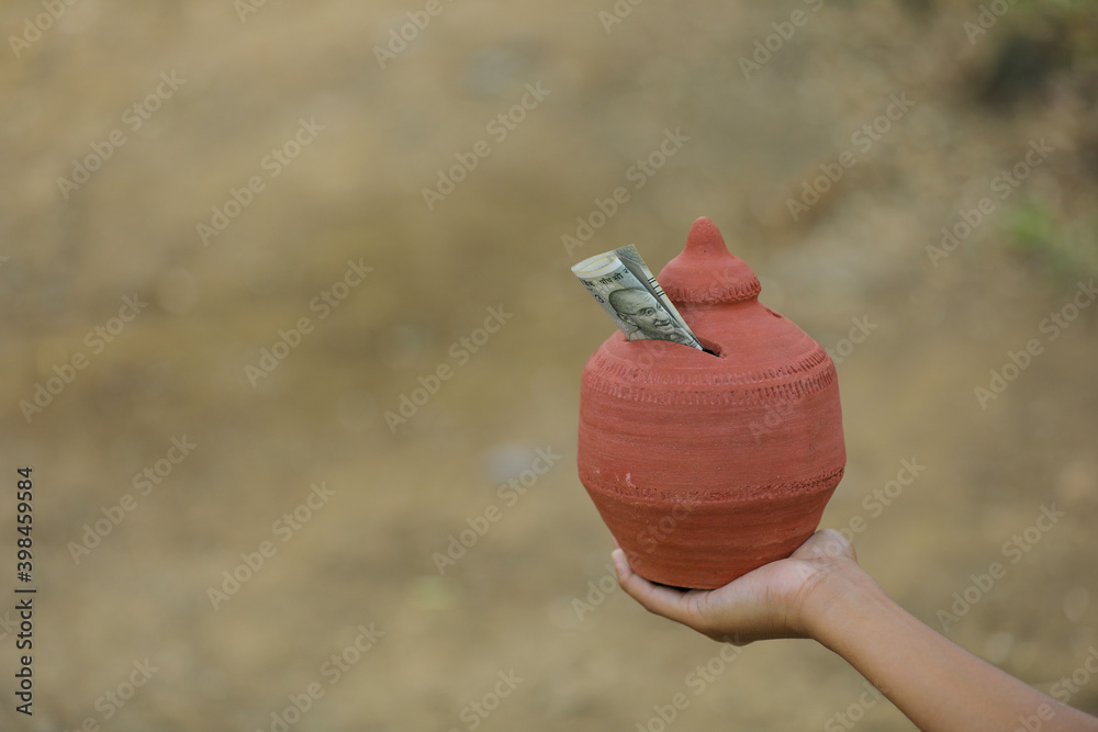 Indian rupees symbol and clay piggy bank Stock Photo | Adobe Stock