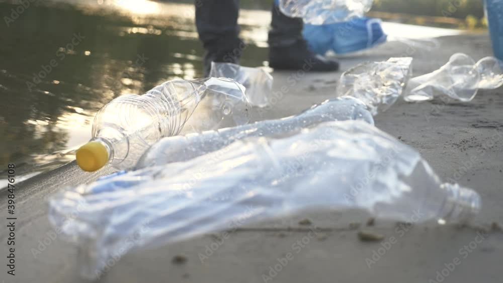 Teamwork of people cleaning up trash on beach.Close-up - effective work ...