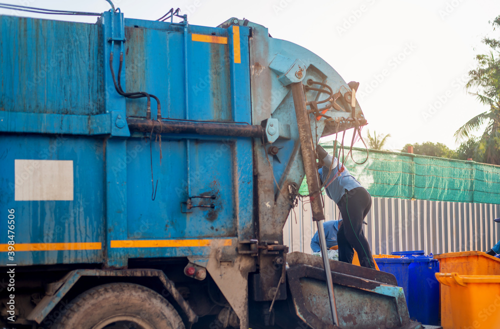 Garbage collector on the garbage truck.Sweeper or Worker are loading ...