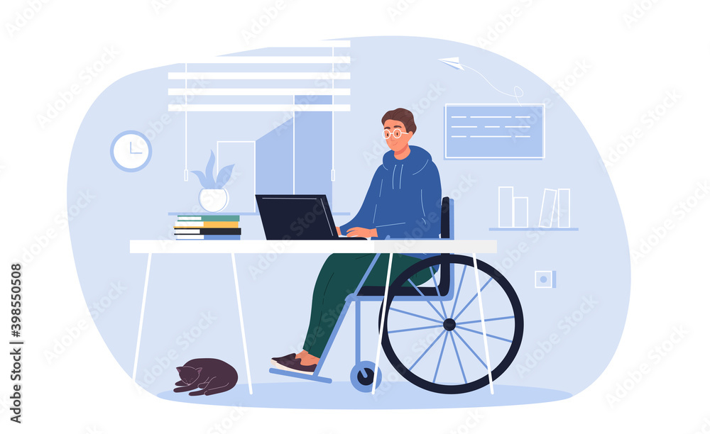 Young disabled man in wheelchair working on laptop computer at home or ...