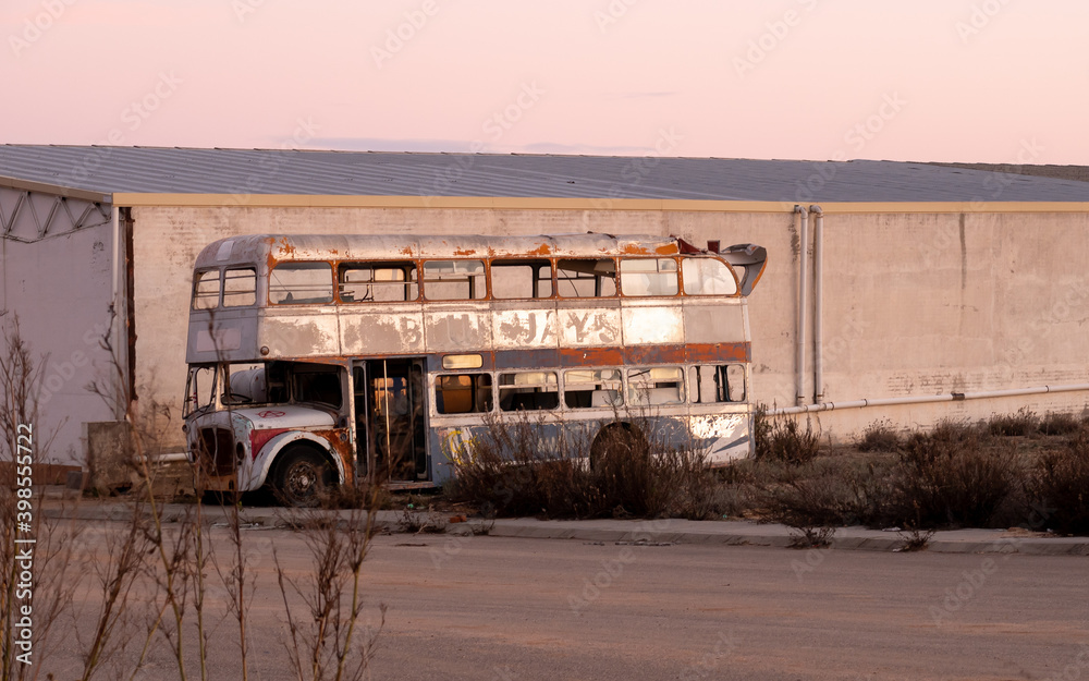 OLD TWO STORY BUS DESTROYED IN THE MIDDLE OF THE FIELD Stock Photo ...
