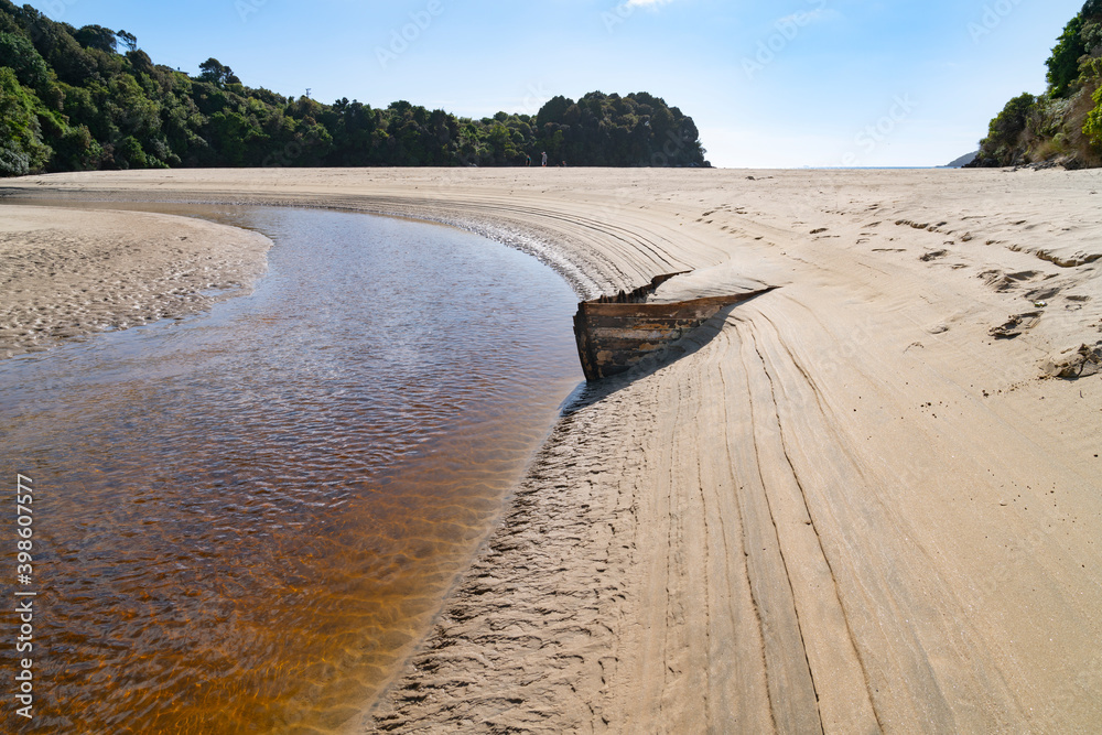 Lines and patterns curving along edge of stream interupted by bow of ...