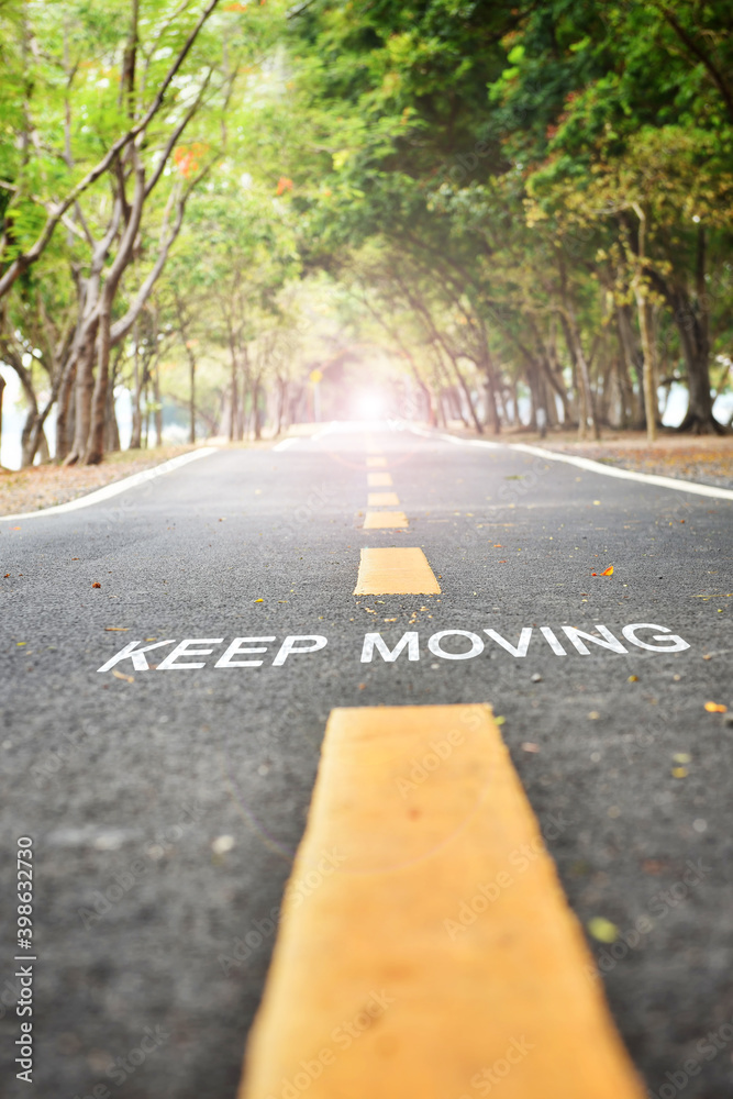 Keep moving word with yellow line marking on road surface. Business ...
