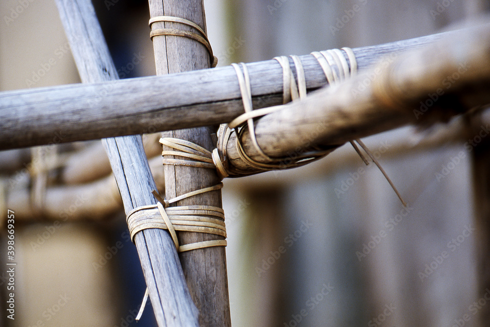 Detail of bamboo scaffolding in use on a small building construction ...