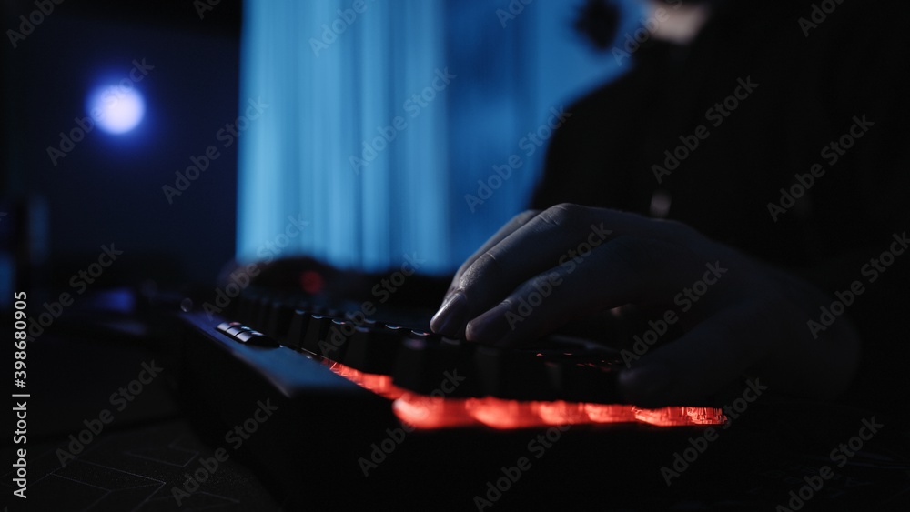Hand on keyboard at night Stock Photo | Adobe Stock
