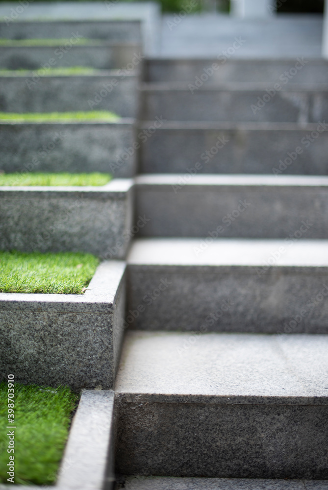 Neat and tidy grey stair steps made of stone and granite tiles with a ...