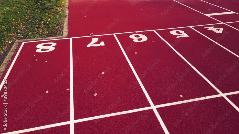 Aerial footage of running track in a sport stadium. first person view ...