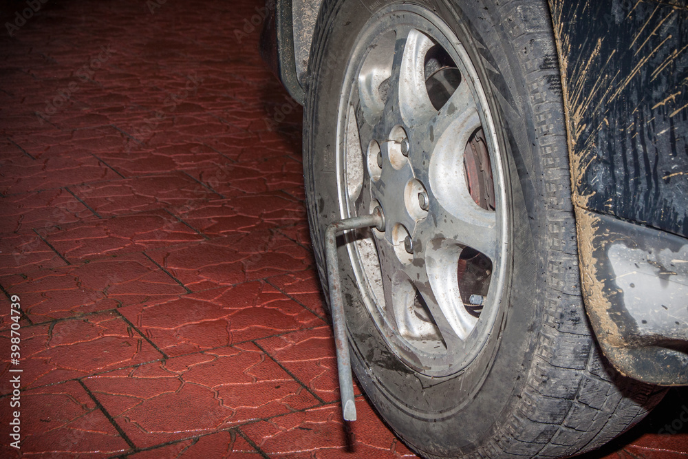 The wheel key is placed on the wheel of the car. Seasonal tire ...