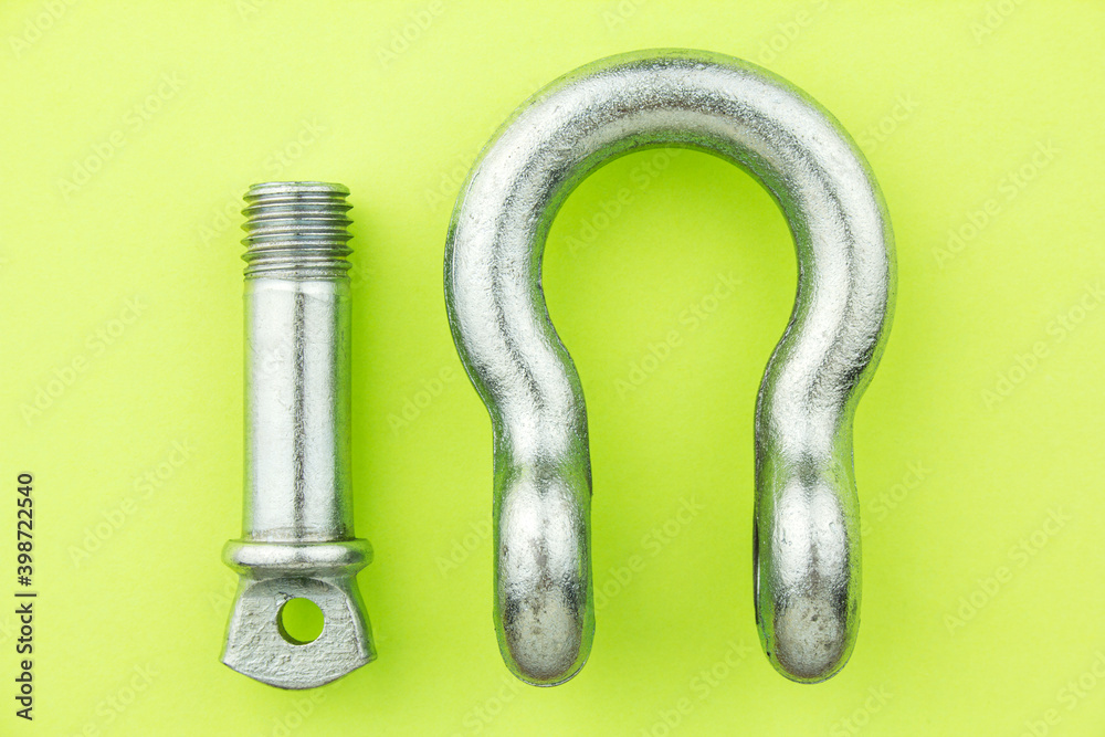 Steel metal rigging shackle wih screw pin anchor on green background ...