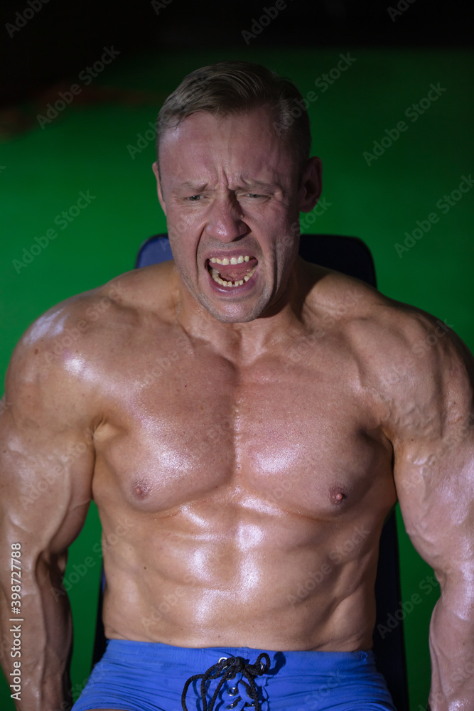 Man athlete trains the muscles of the legs on the simulator Stock Photo ...