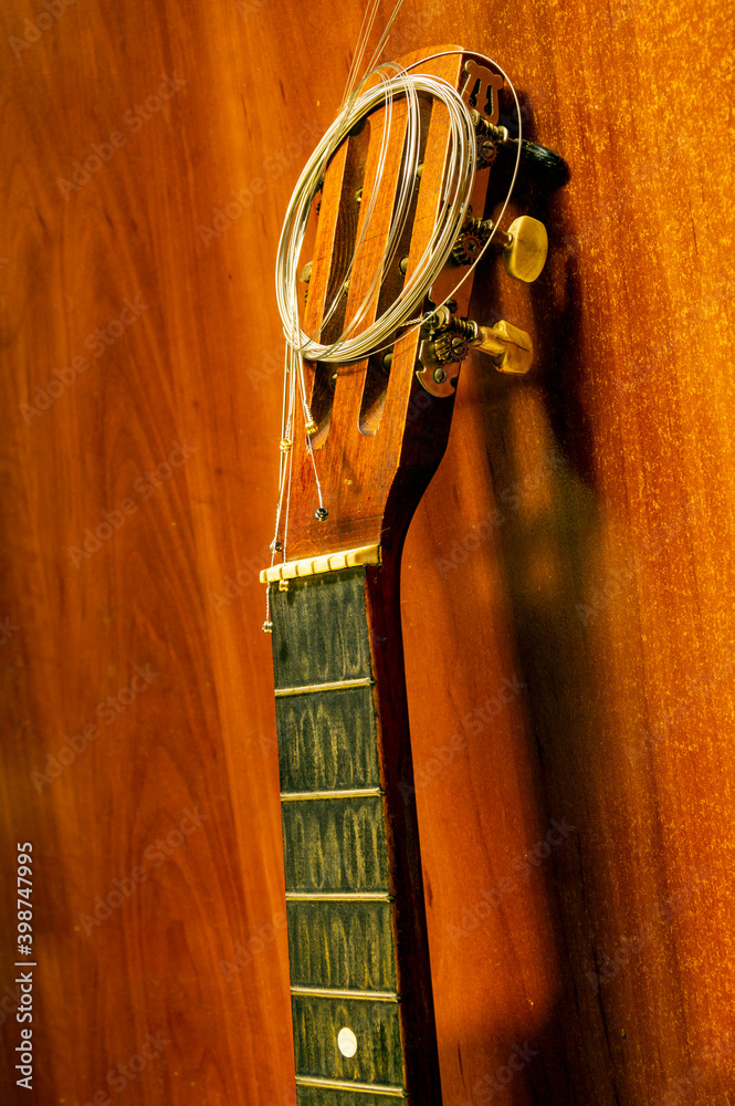 New strings for a six-string guitar are prepared. Stock Photo | Adobe Stock
