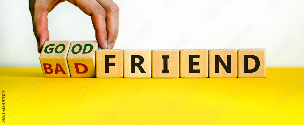 Good or bad friend symbol. Male hand turns wooden cubes and changes ...
