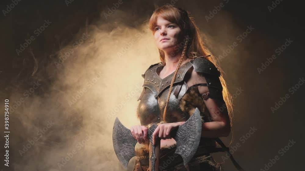 Positive and beautiful scandinavian valkyrie in antique clothing poses ...