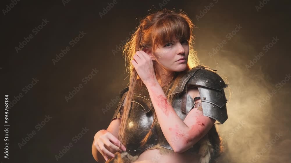 Authentic portrait of a charming nordic valkyrie posing in dark ...