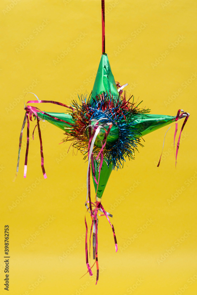 Colorful traditional mexican pinata hanging on yellow background ...