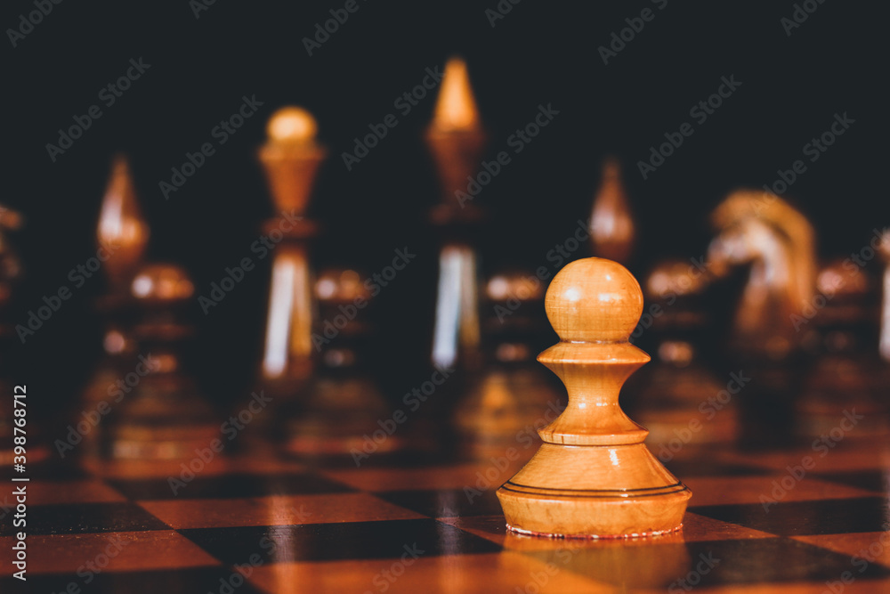 Game of chess. Wooden chess pieces. A pawn on a chess table. Strategy ...