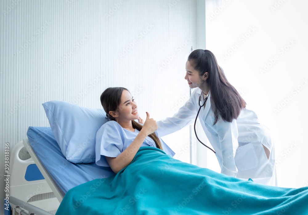 Asian young female patient on bed showing thumbs up with smiley face ...