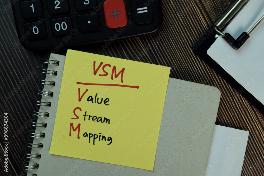 VSM - Value Stream Mapping write on sticky notes isolated on Wooden ...