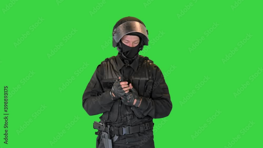 Swat soldier in full uniform using radio on a Green Screen, Chroma Key ...