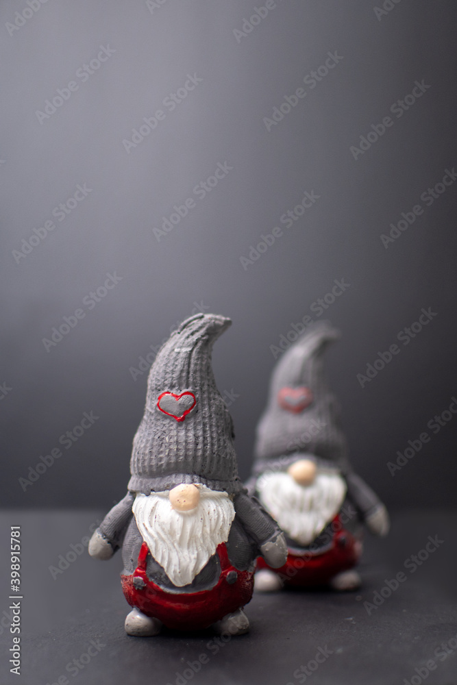 Tomte in focus wearing red scandinavian skirt standing in front of ...