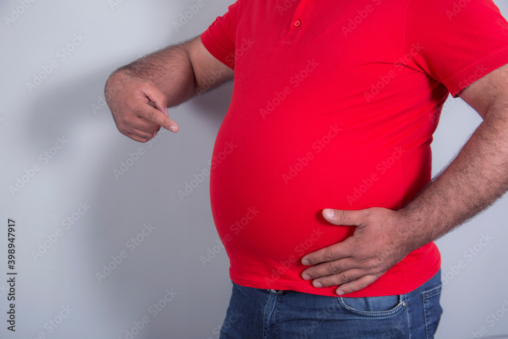 fat man points his finger at his belly Stock Photo | Adobe Stock
