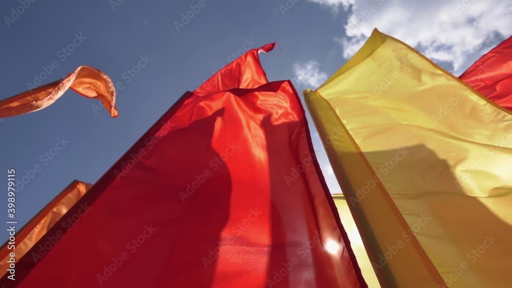 Close-up of waving festival flags filmed from below in slow motion on a ...