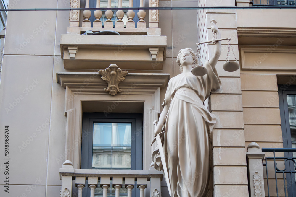 The statue of justice with a scales and a sword in his hand was carved ...
