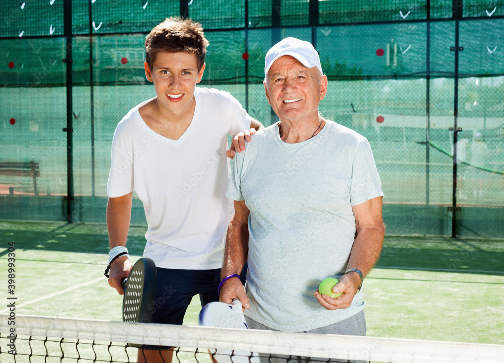 padel players of different generations posing on padel court Stock ...
