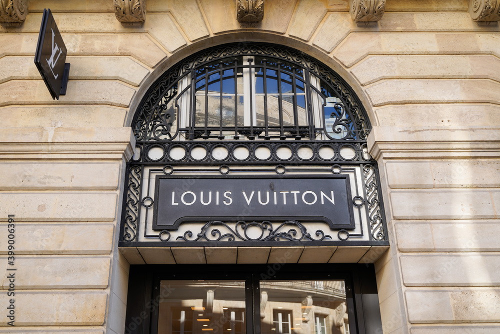 louis vuitton logo and sign text front of store fashion brand clothes ...