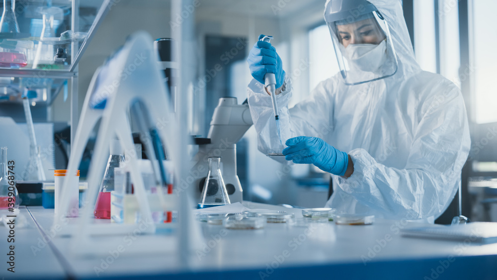 Beautiful Female Medical Scientist Wearing Coverall and Face Mask Using ...
