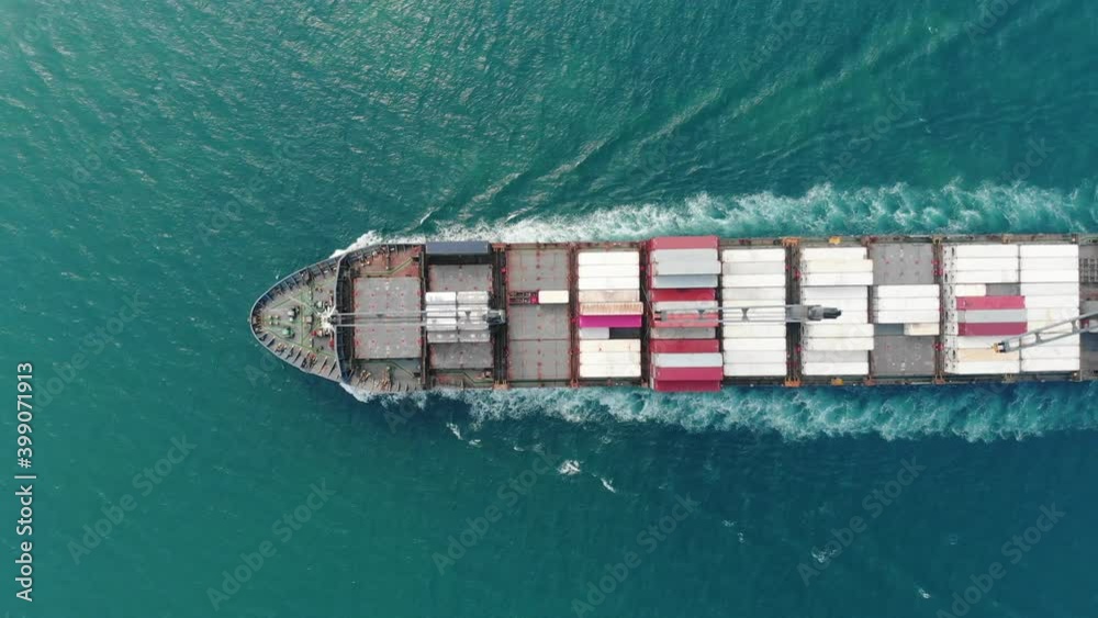 Aerial top view of cargo ship carrying container and running very fast ...