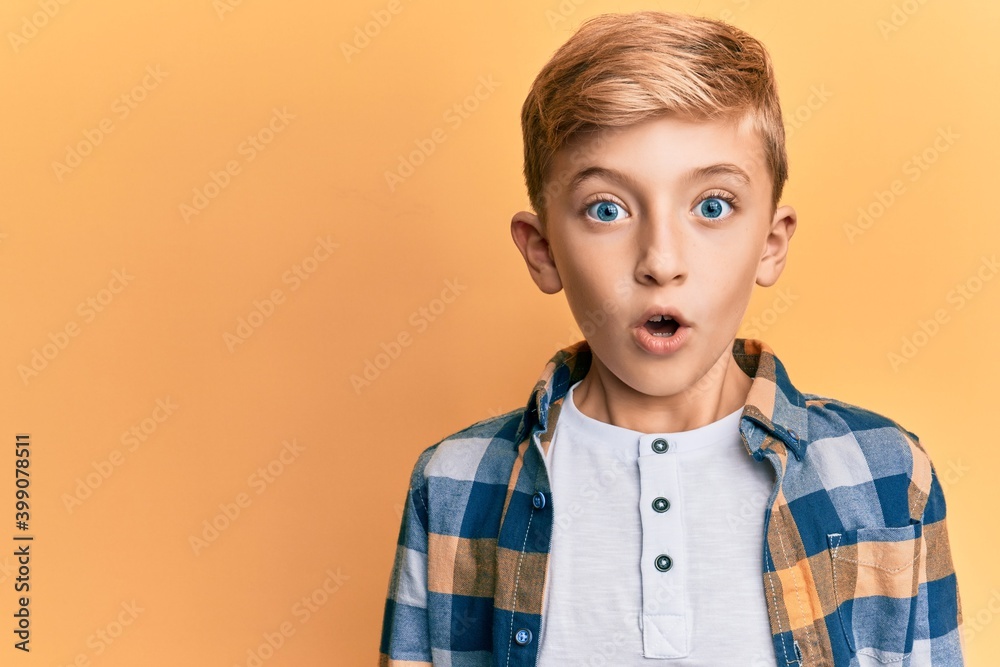 Little caucasian boy kid wearing casual clothes scared and amazed with ...