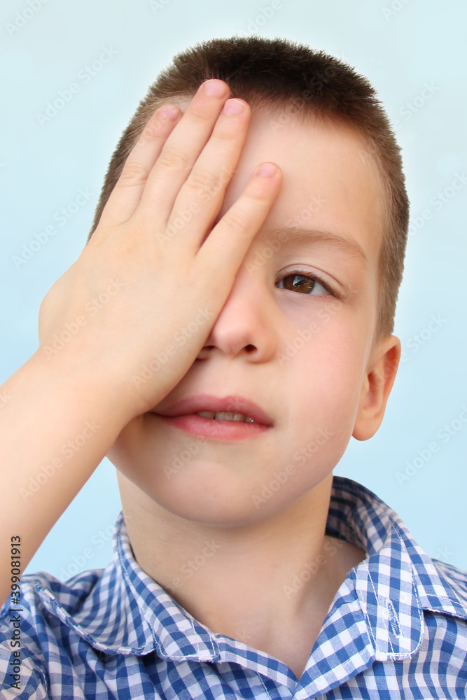 boy, kid, part of the face, covered one eye with a palm, vision test ...