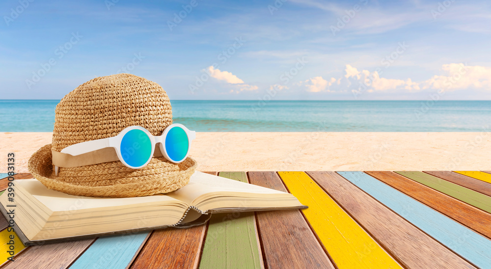 Open book on multicolor wood panel and sea beach background.Summer ...