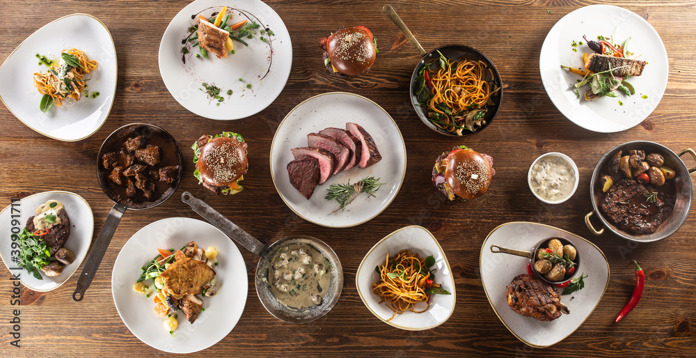 Top view of a table full of various meals for vegetarians and meat ...