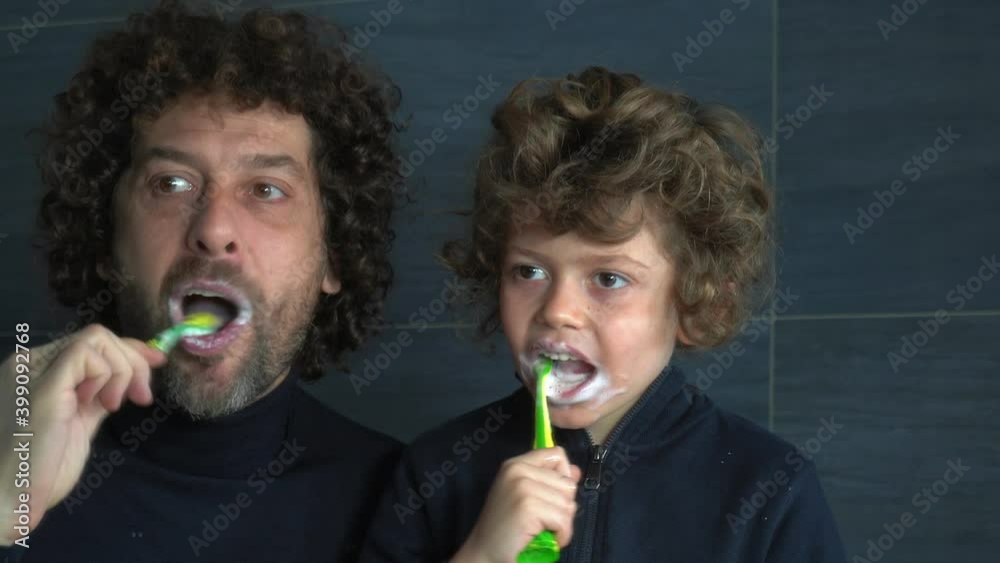 Father teaching little kid teeth brushing and washing his face. Dad and ...