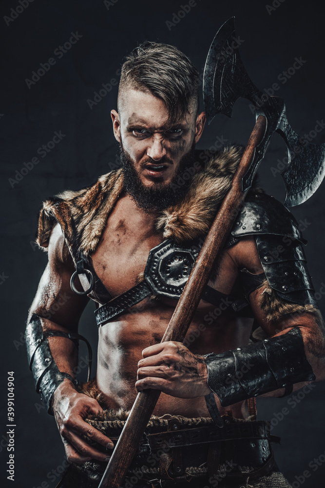 Northern savage warrior with muscular build staring at camera holds his ...