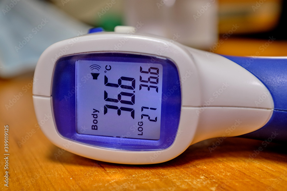 Measure of body temperature by infrared thermometer. Display of a ...