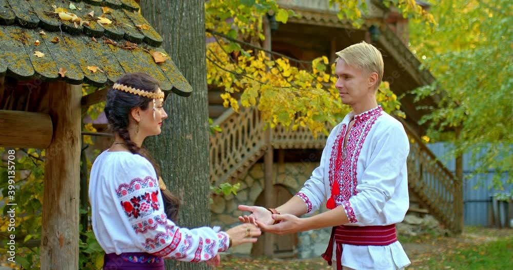 Portrait, a man in a folk shirt with embroidery takes a beautiful woman ...