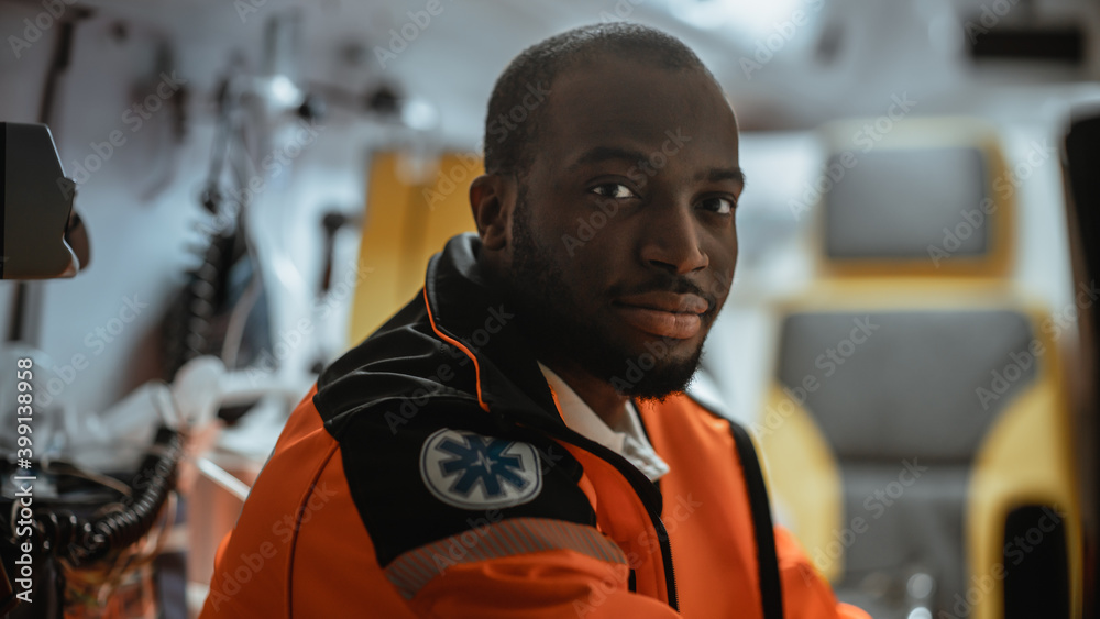 Black African American Paramedic Looking into Camera in an Ambulance ...